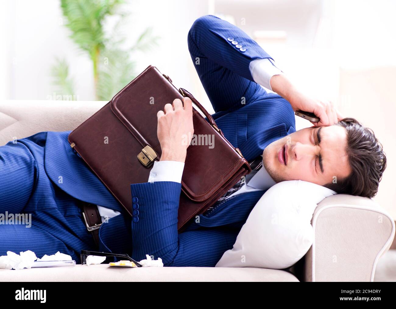 The sick employee staying at home suffering from flue Stock Photo - Alamy