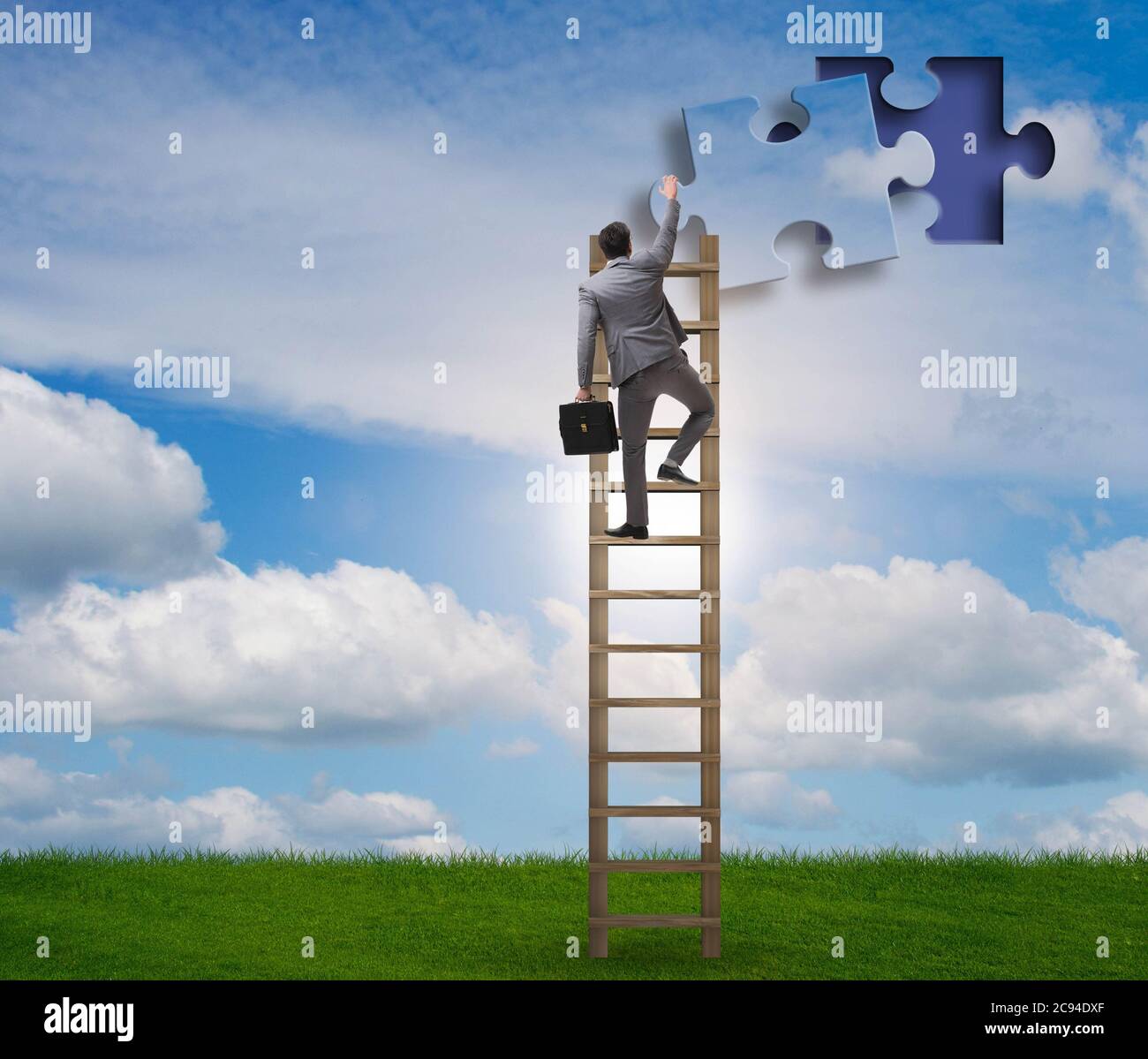 The businessman putting together jigsaw puzzle pieces Stock Photo - Alamy