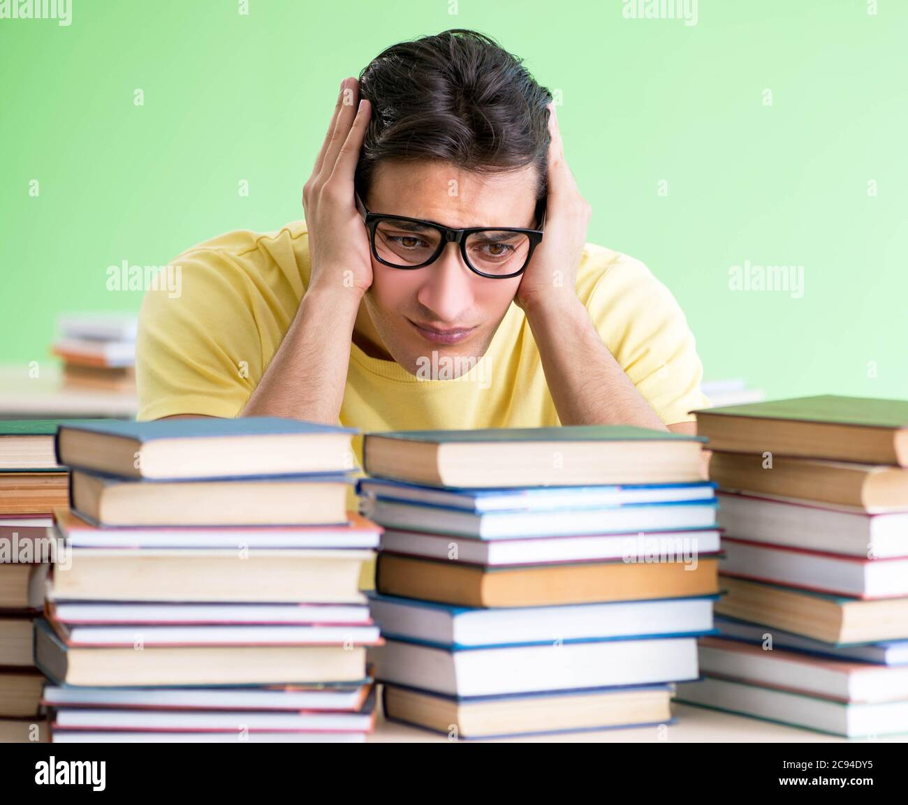 The student with too many books to read before exam Stock Photo - Alamy