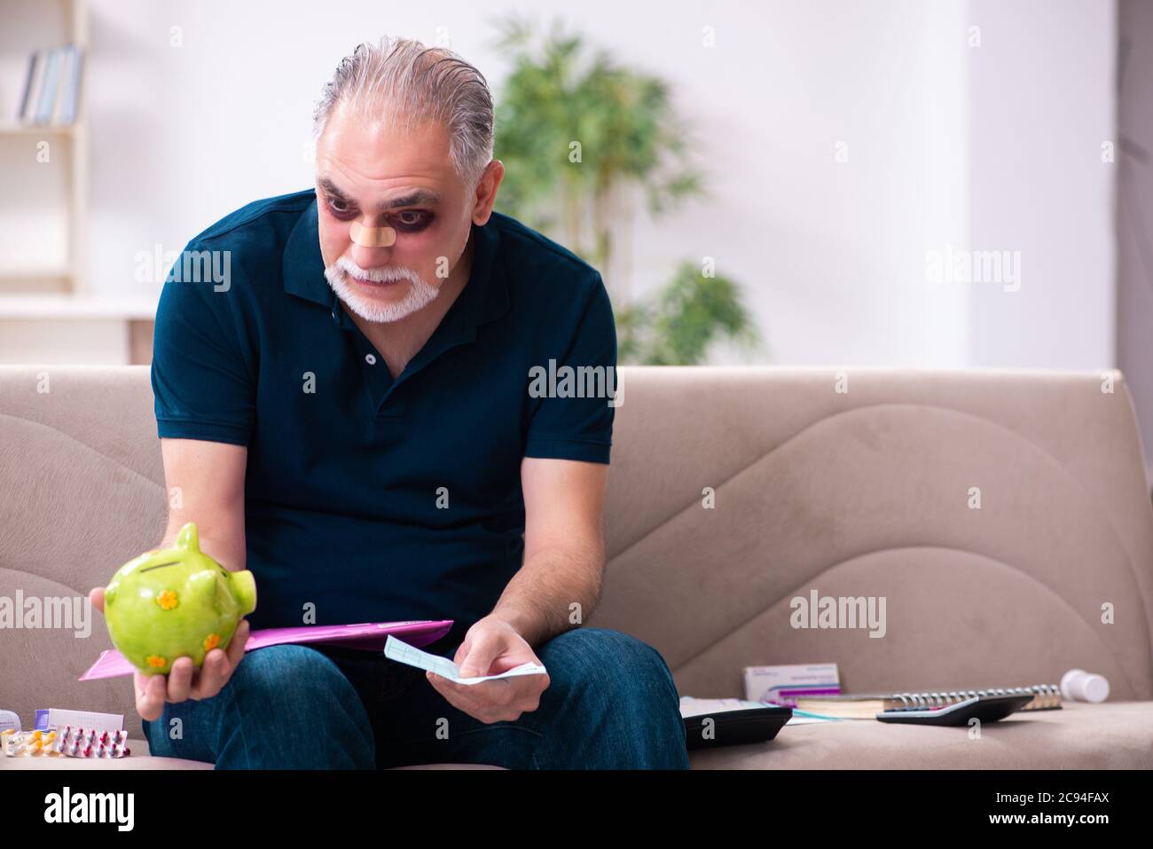 Old man in budget planning concept Stock Photo - Alamy