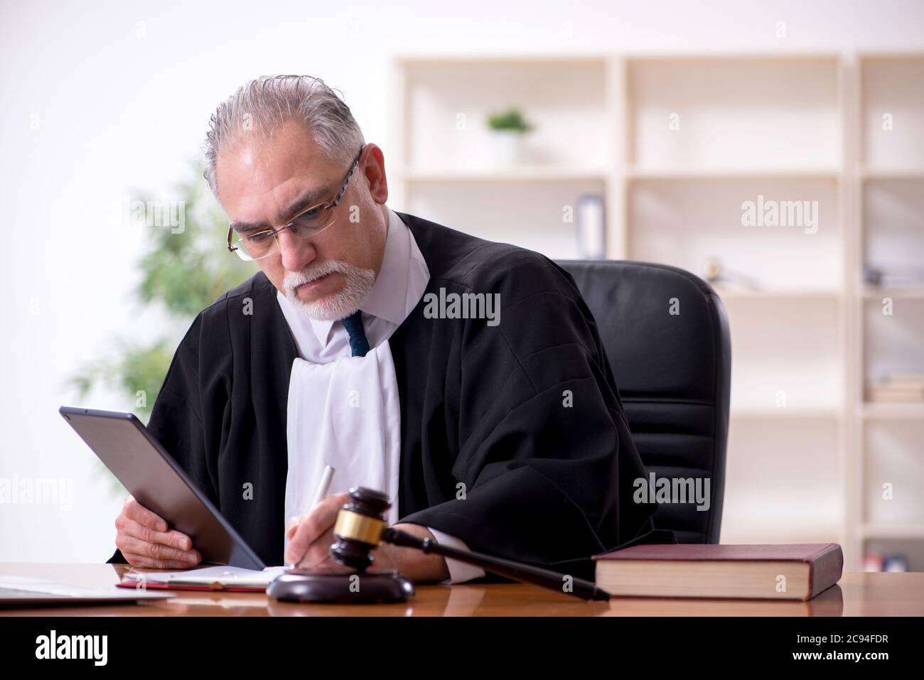 Old judge working in courthouse Stock Photo - Alamy