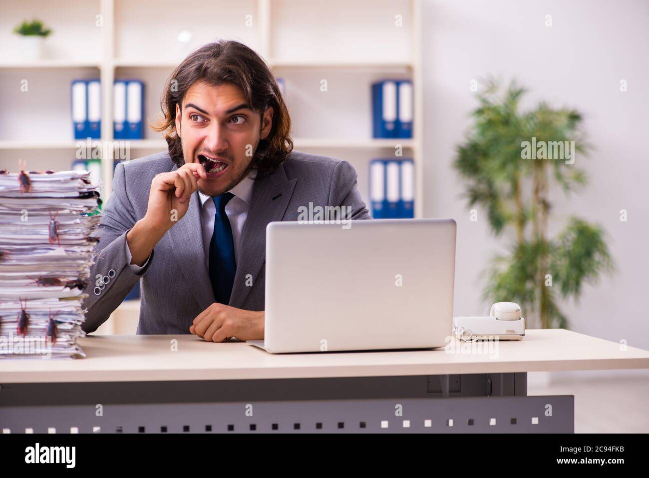 Young employee and too many cockroaches in the office Stock Photo - Alamy
