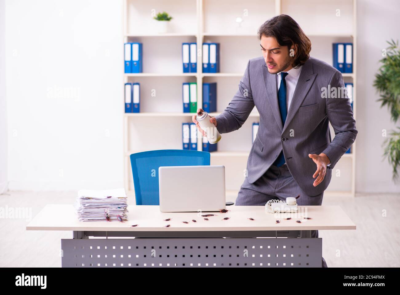 Young employee and too many cockroaches in the office Stock Photo - Alamy