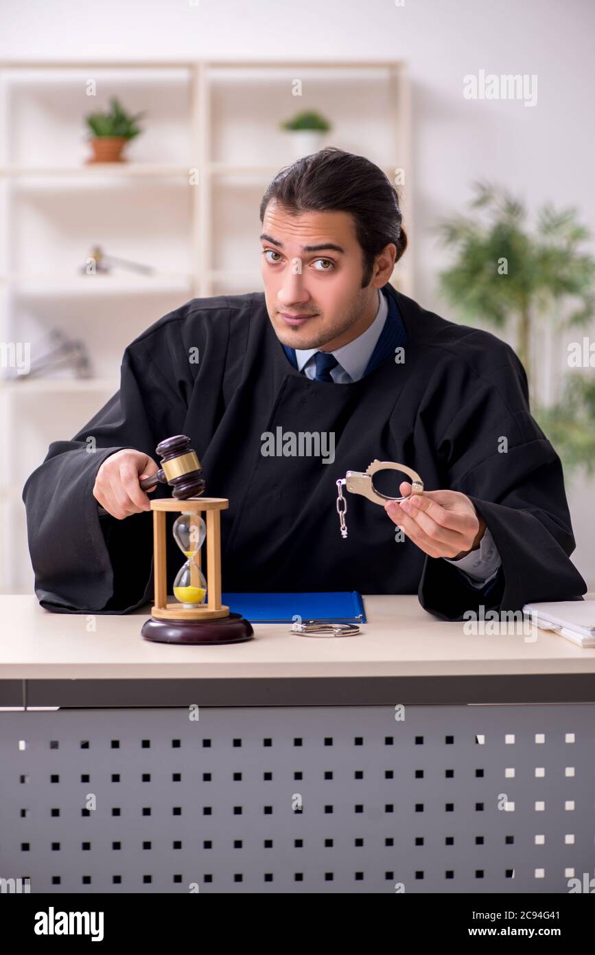 Young judge in time management concept Stock Photo - Alamy