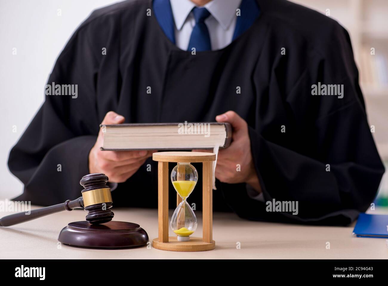 Young judge in time management concept Stock Photo - Alamy