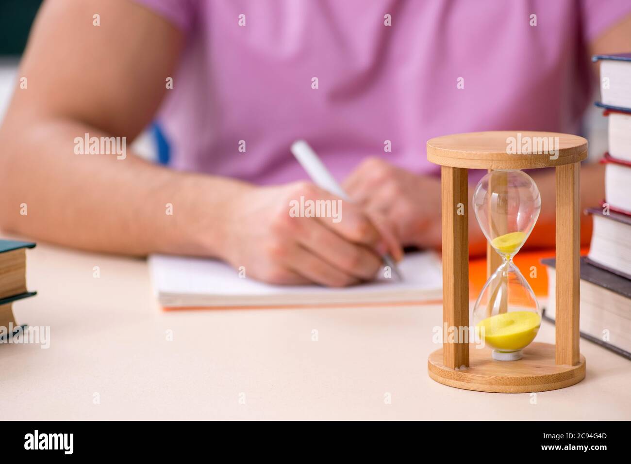 Young student in the classroom at time management concept Stock Photo ...