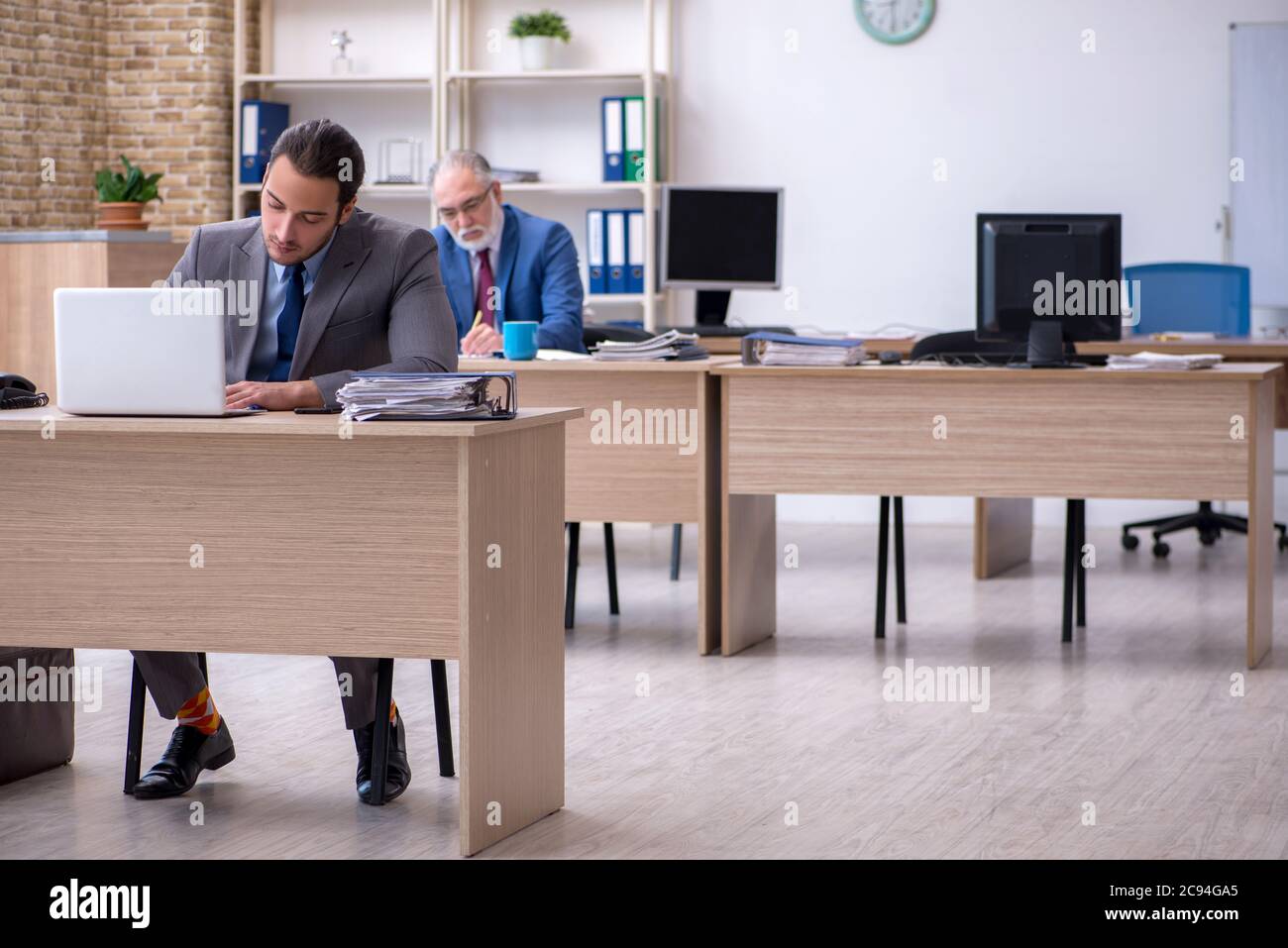 Two employees working in the office Stock Photo - Alamy
