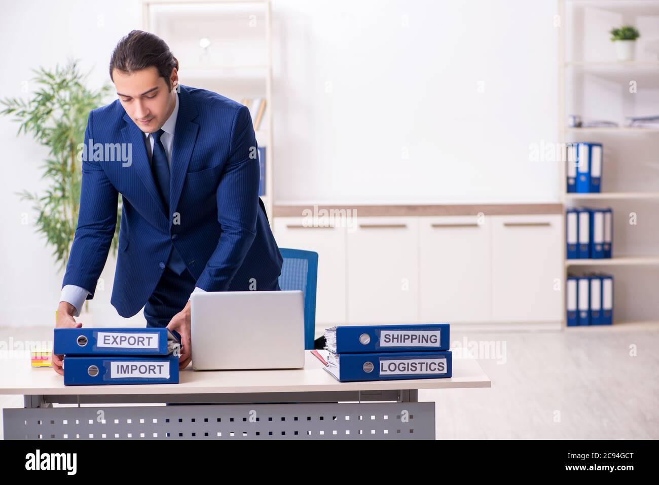 Young logistics specialist working in the office Stock Photo - Alamy