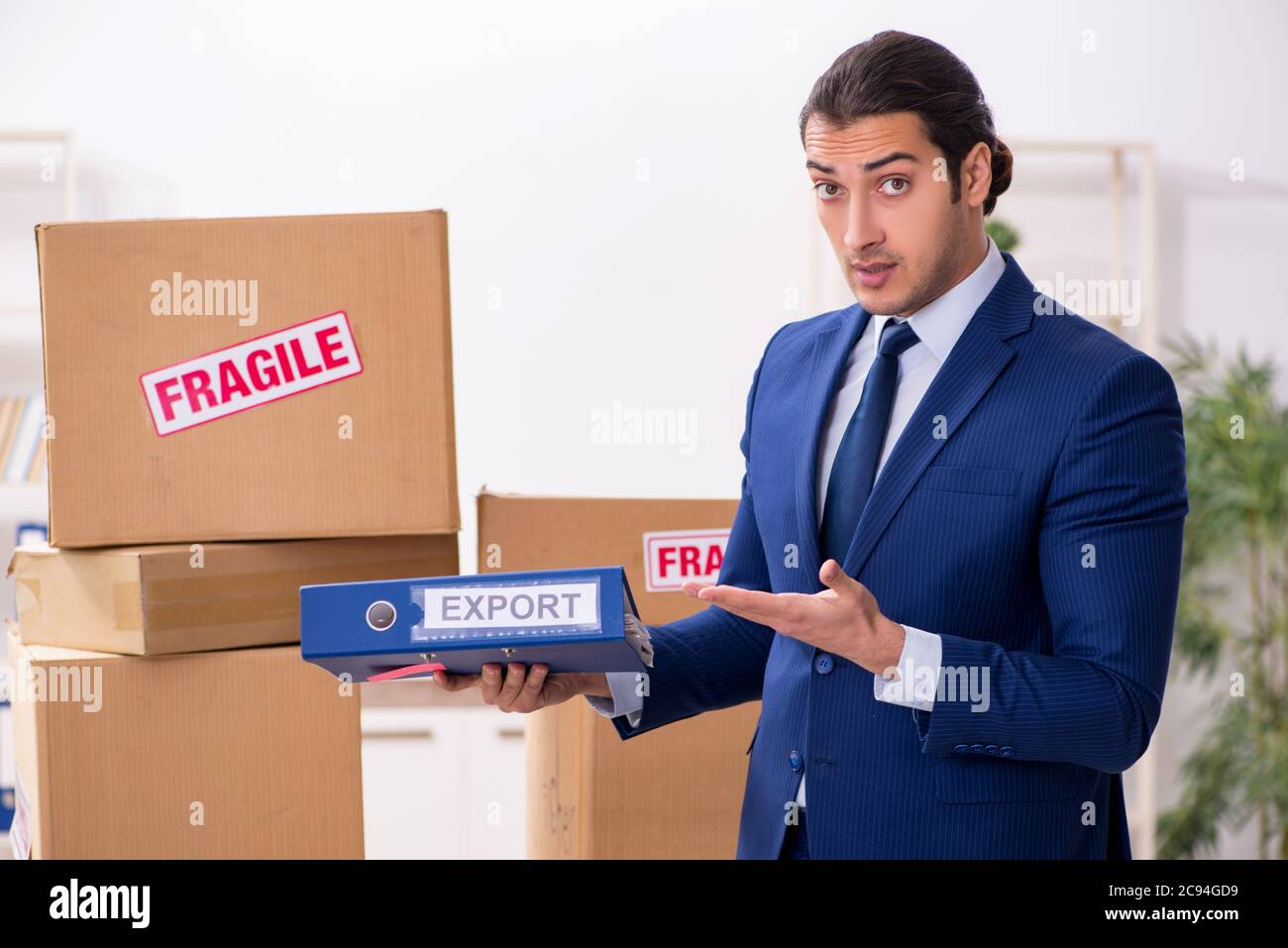 Young logistics specialist working in the office Stock Photo - Alamy