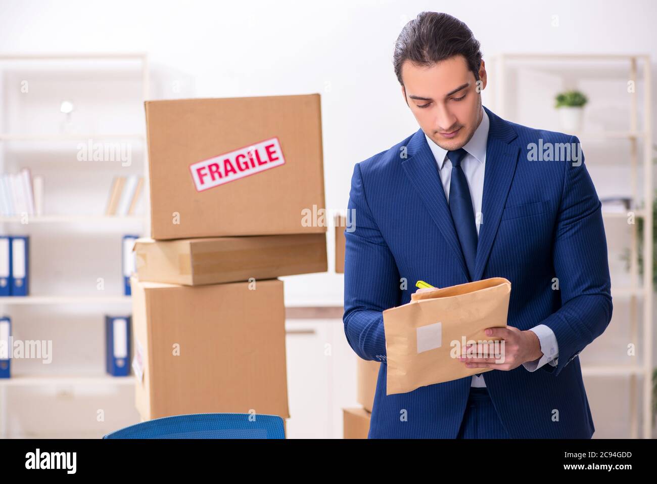 Young logistics specialist working in the office Stock Photo - Alamy