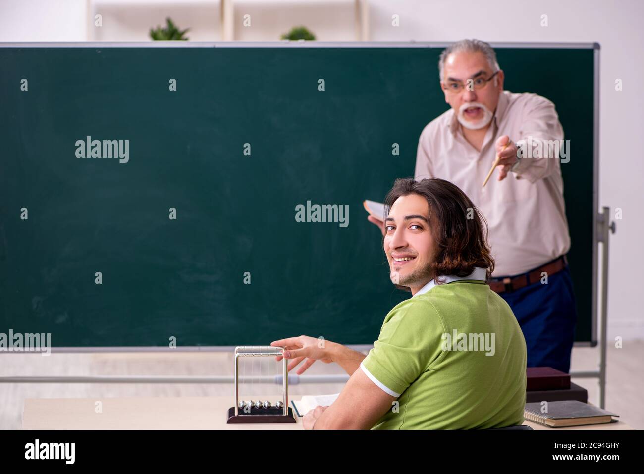 Old professor physicist and student in the classroom Stock Photo - Alamy