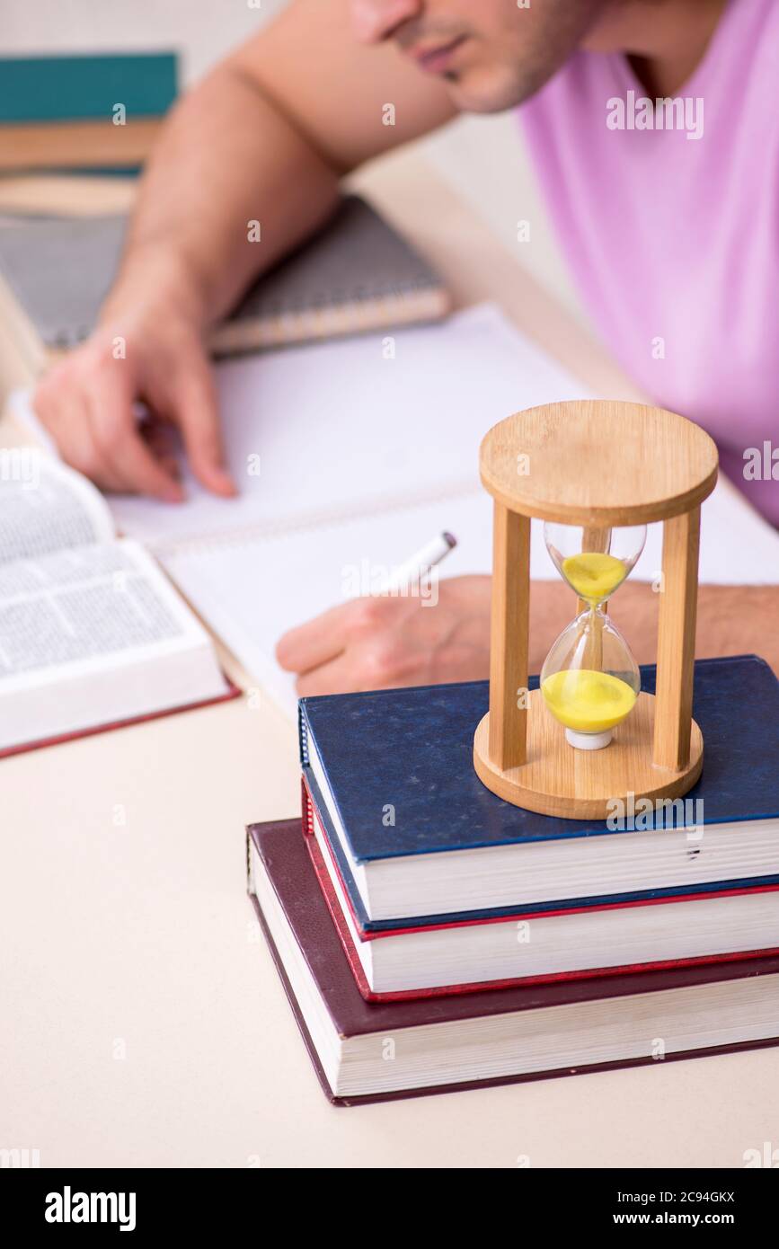 Young student in the classroom at time management concept Stock Photo ...