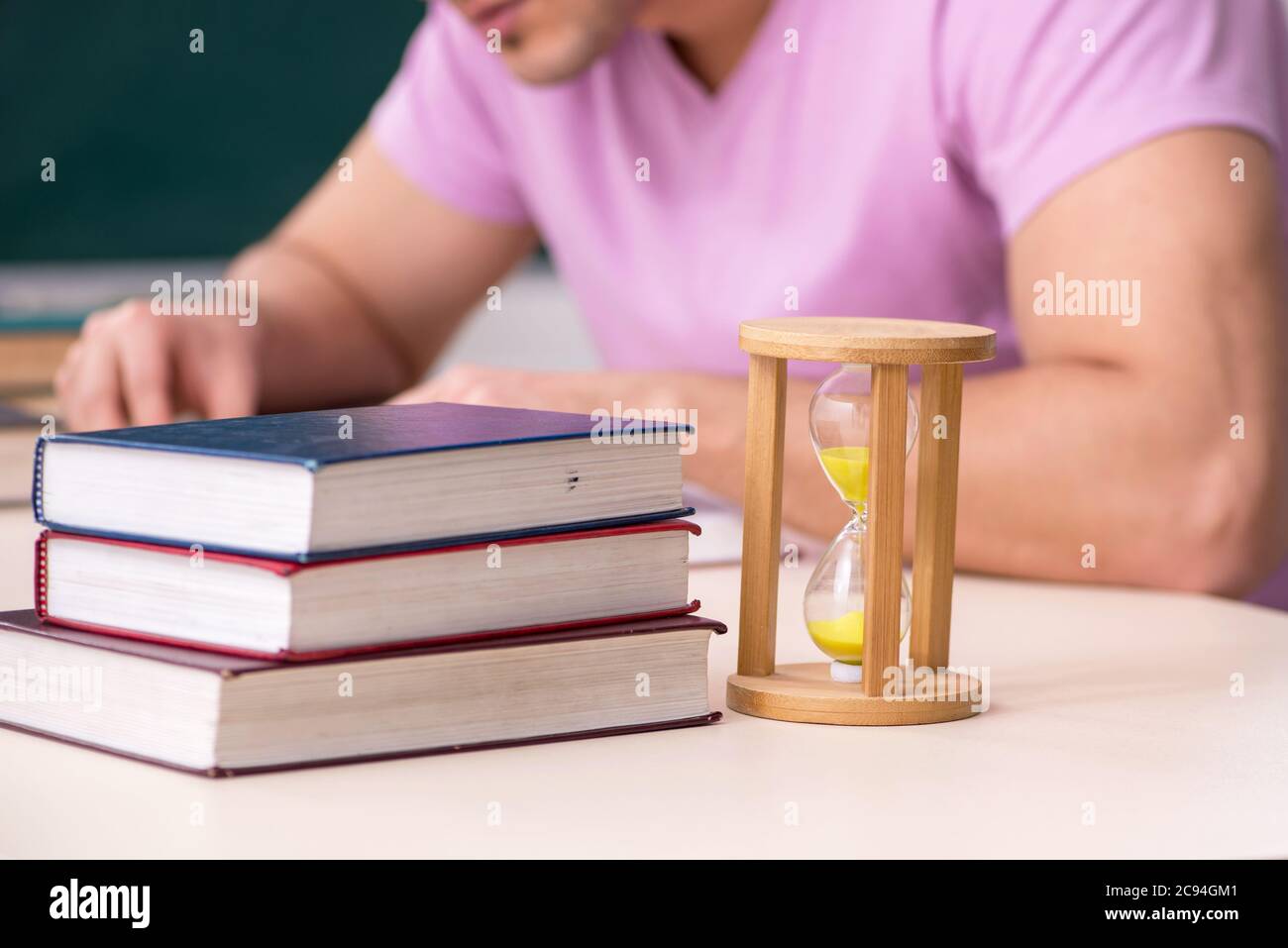 Young student in the classroom at time management concept Stock Photo ...