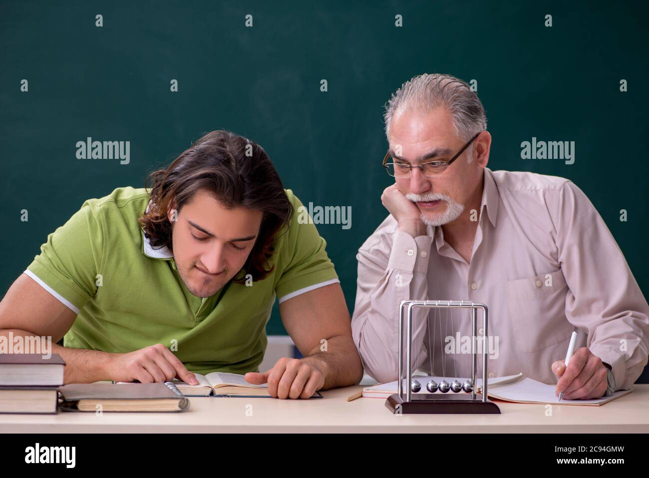 Old professor physicist and student in the classroom Stock Photo - Alamy