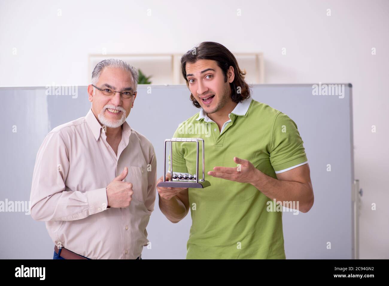 Old professor physicist and student in the classroom Stock Photo - Alamy