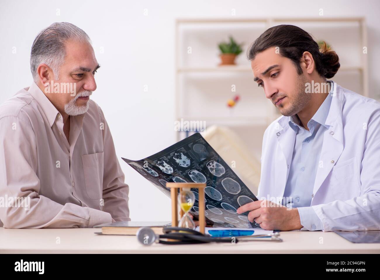 Male patient visiting doctor radiologist in time management concept ...