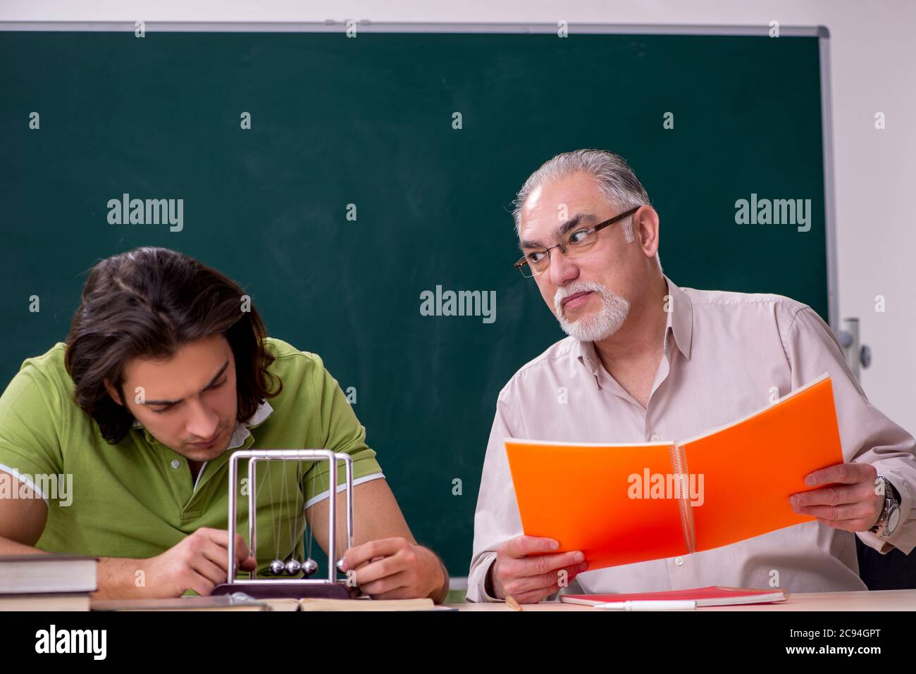 Old professor physicist and student in the classroom Stock Photo - Alamy