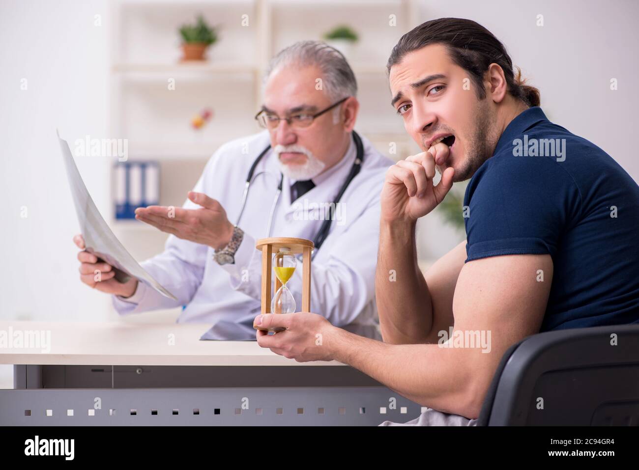 Male patient visiting doctor radiologist in time management concept ...