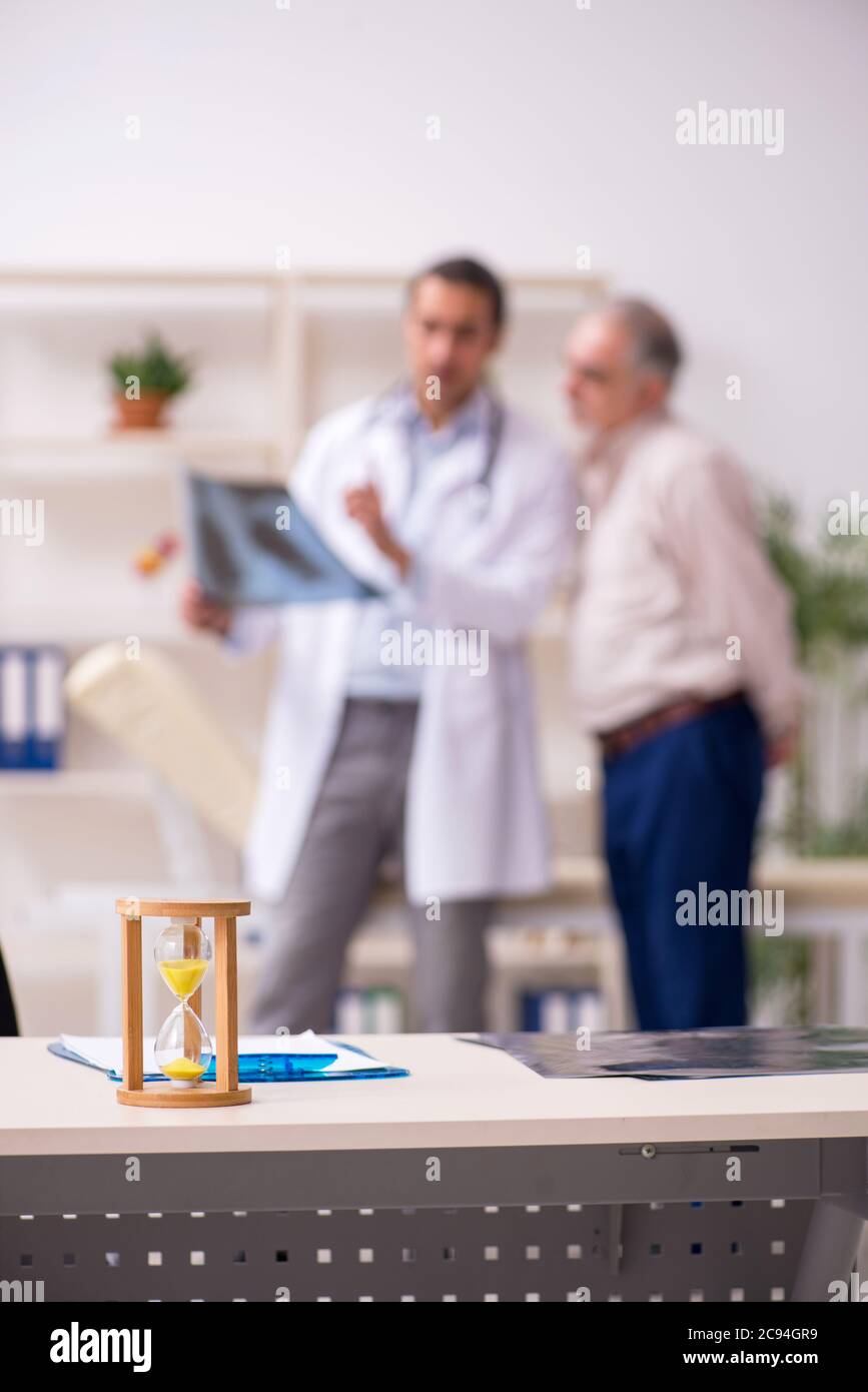 Male patient visiting doctor radiologist in time management concept ...