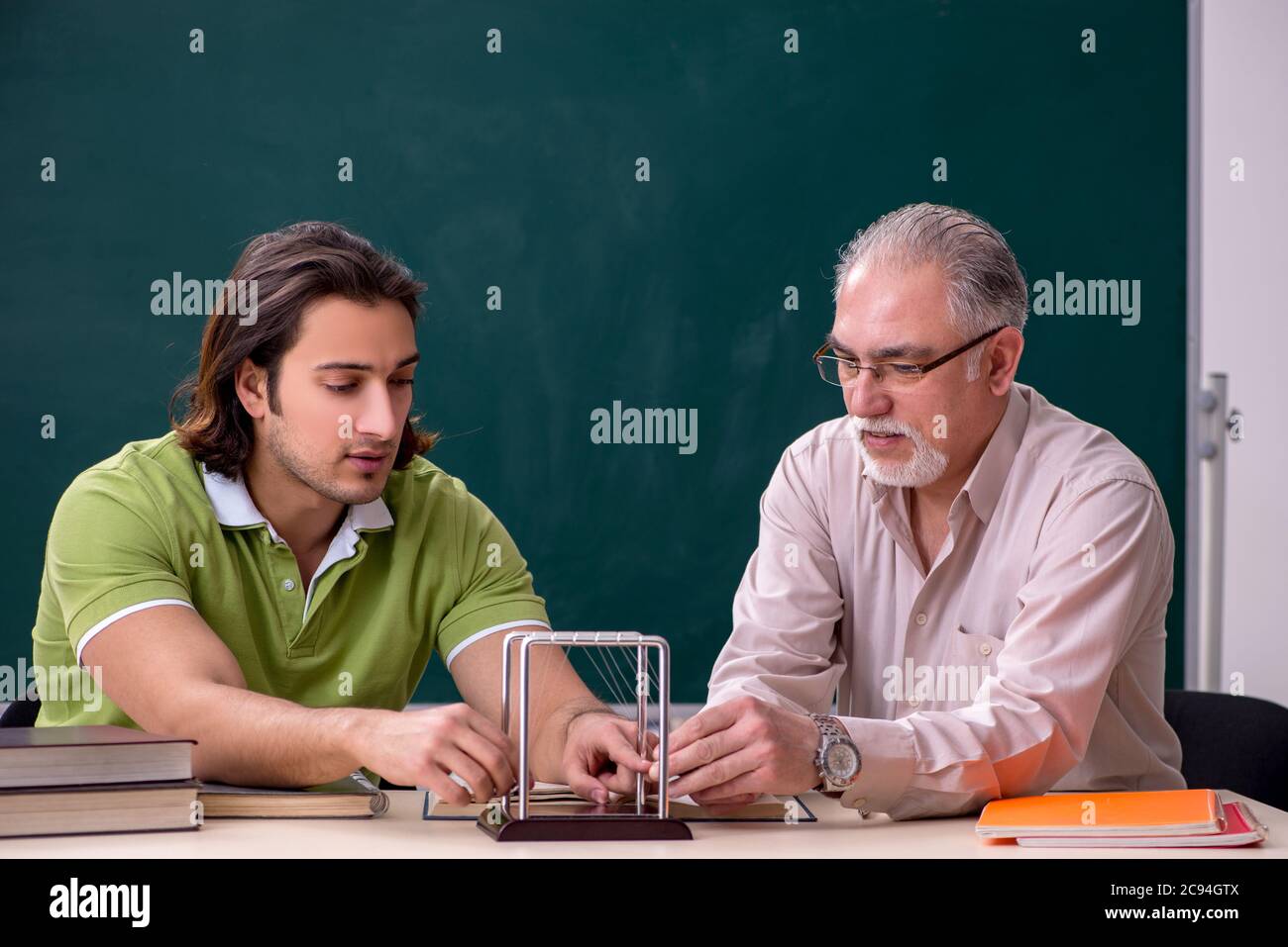Old professor physicist and student in the classroom Stock Photo - Alamy