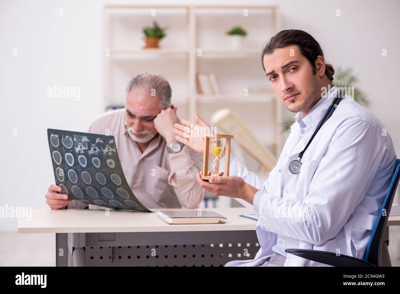Male patient visiting doctor radiologist in time management concept ...