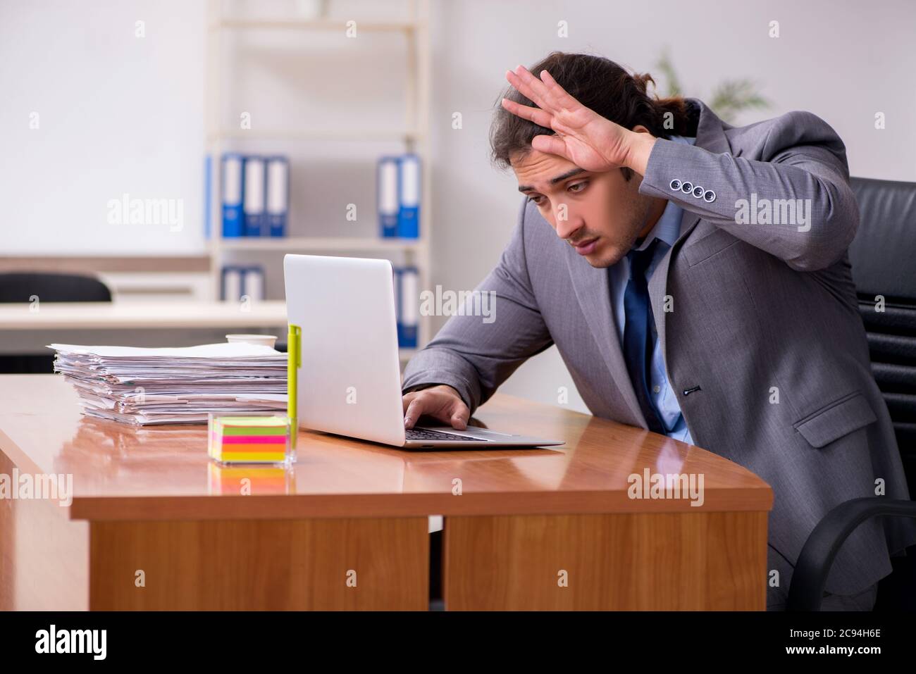 Young employee sleeping in the office Stock Photo - Alamy