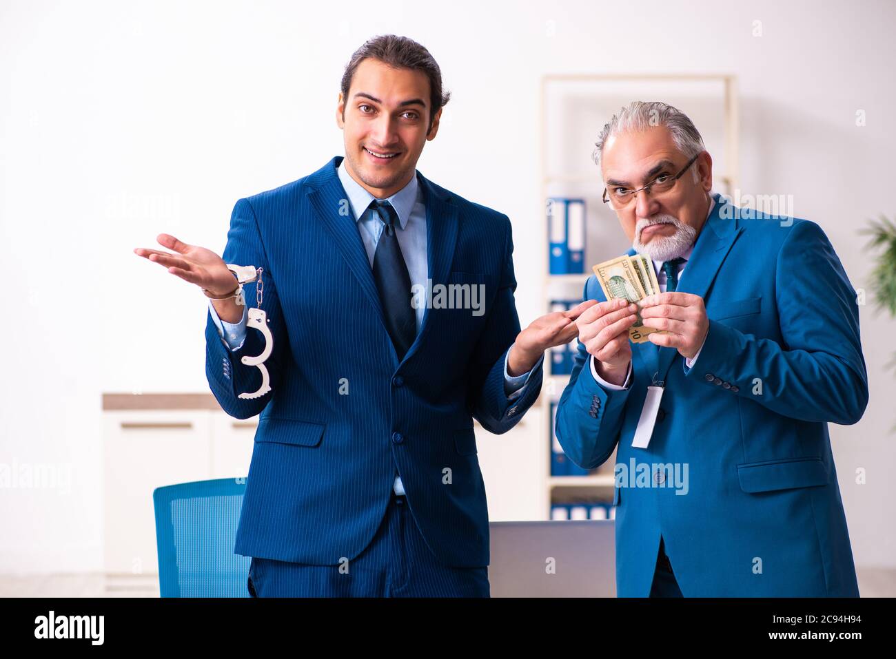 Male employee and cop in police investigation Stock Photo - Alamy