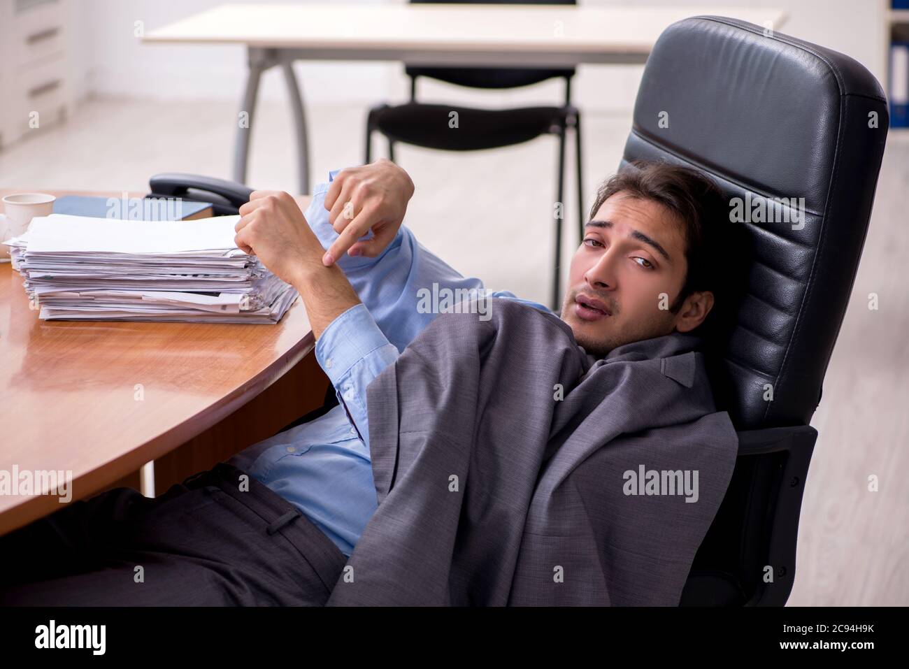 Young employee sleeping in the office Stock Photo - Alamy
