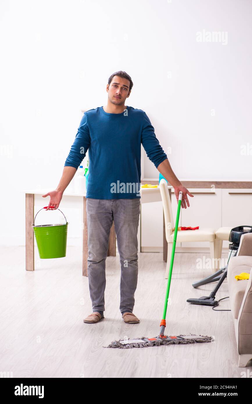 Young man husband doing housework at the home Stock Photo - Alamy