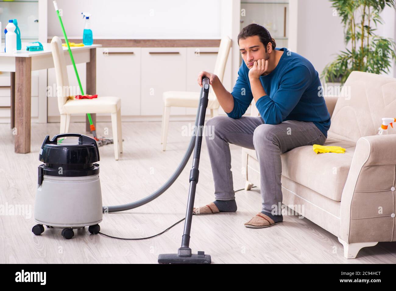 Young man husband doing housework at the home Stock Photo - Alamy