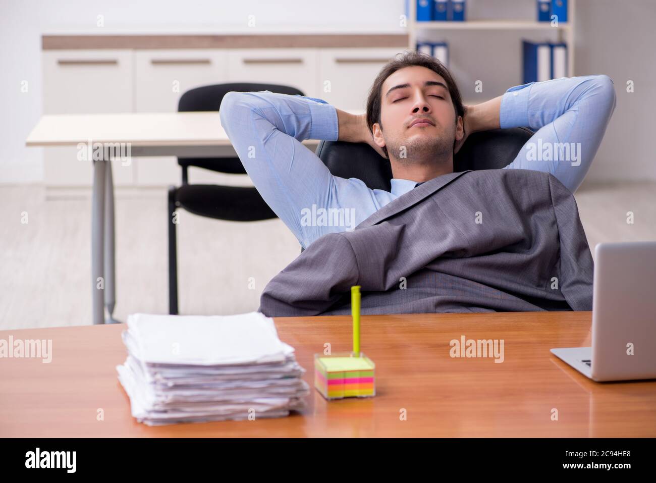 Young employee sleeping in the office Stock Photo - Alamy