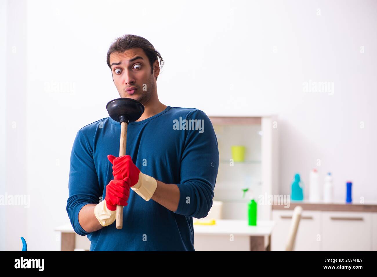Young man husband doing plumbing at the home Stock Photo - Alamy