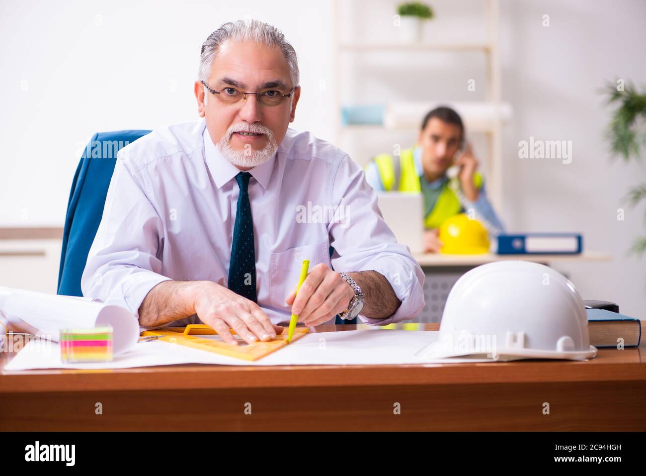 Two architects working in the office Stock Photo - Alamy
