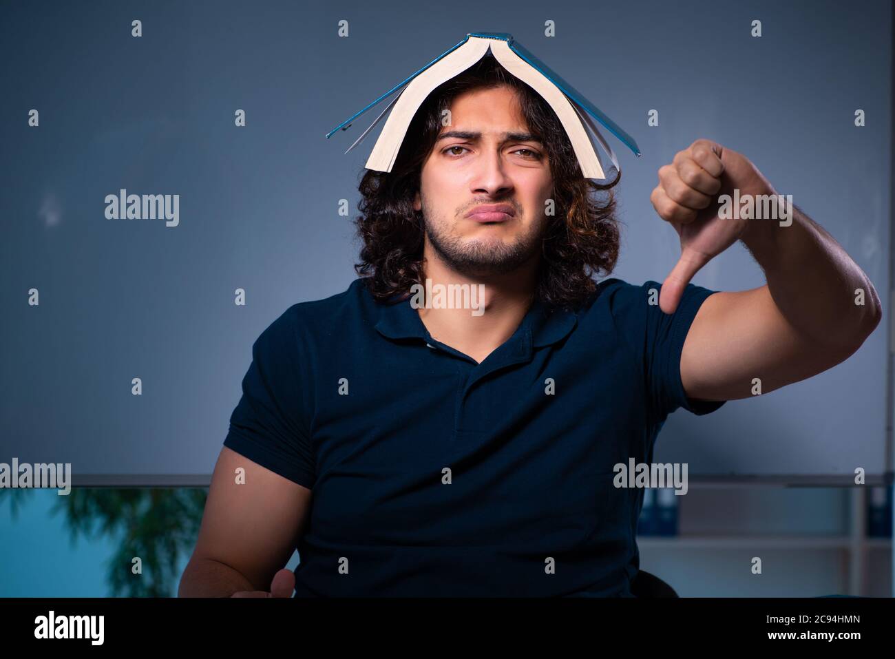 Young student in the classroom at night Stock Photo - Alamy