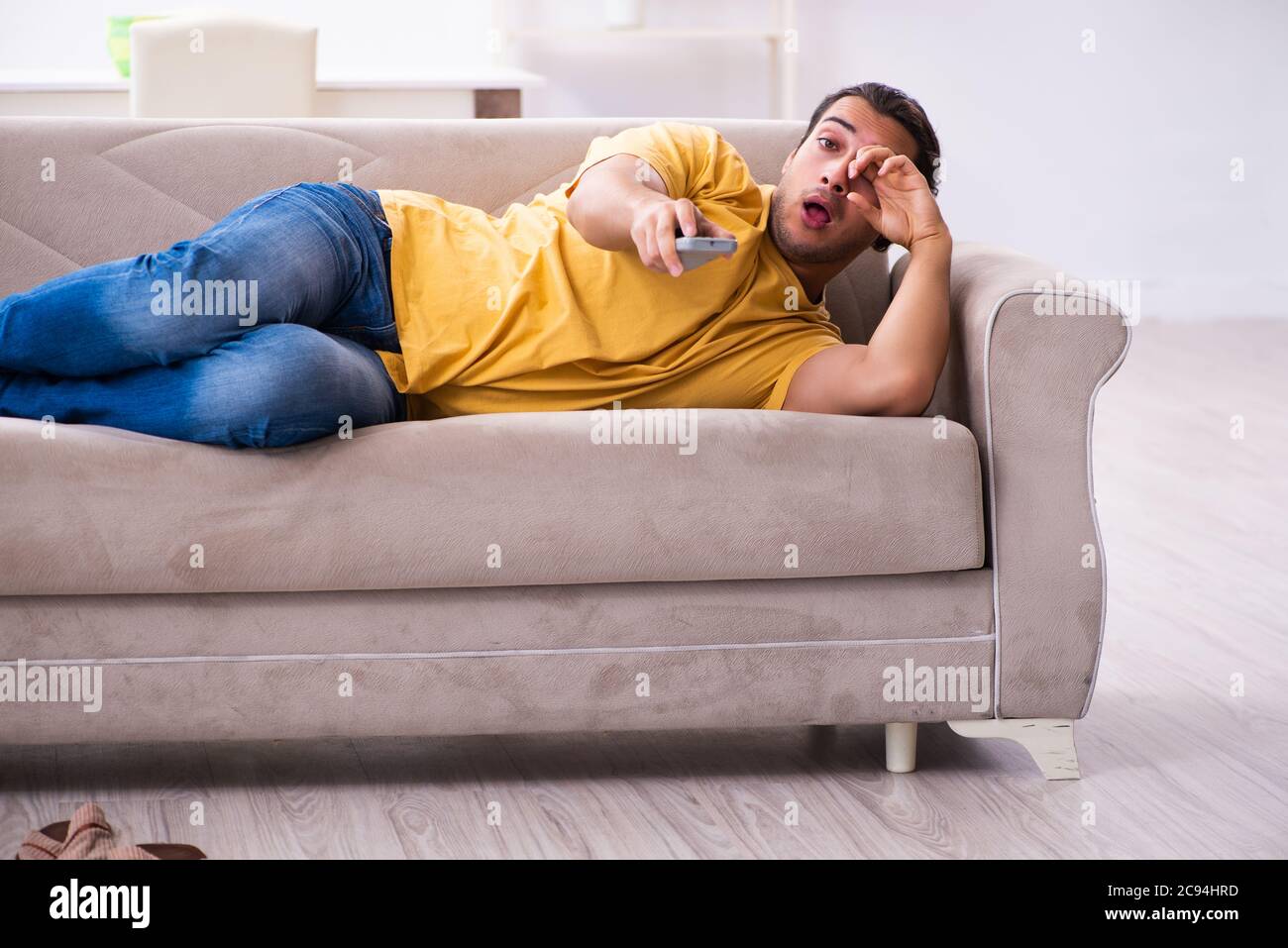 Young man watching tv at the home Stock Photo - Alamy