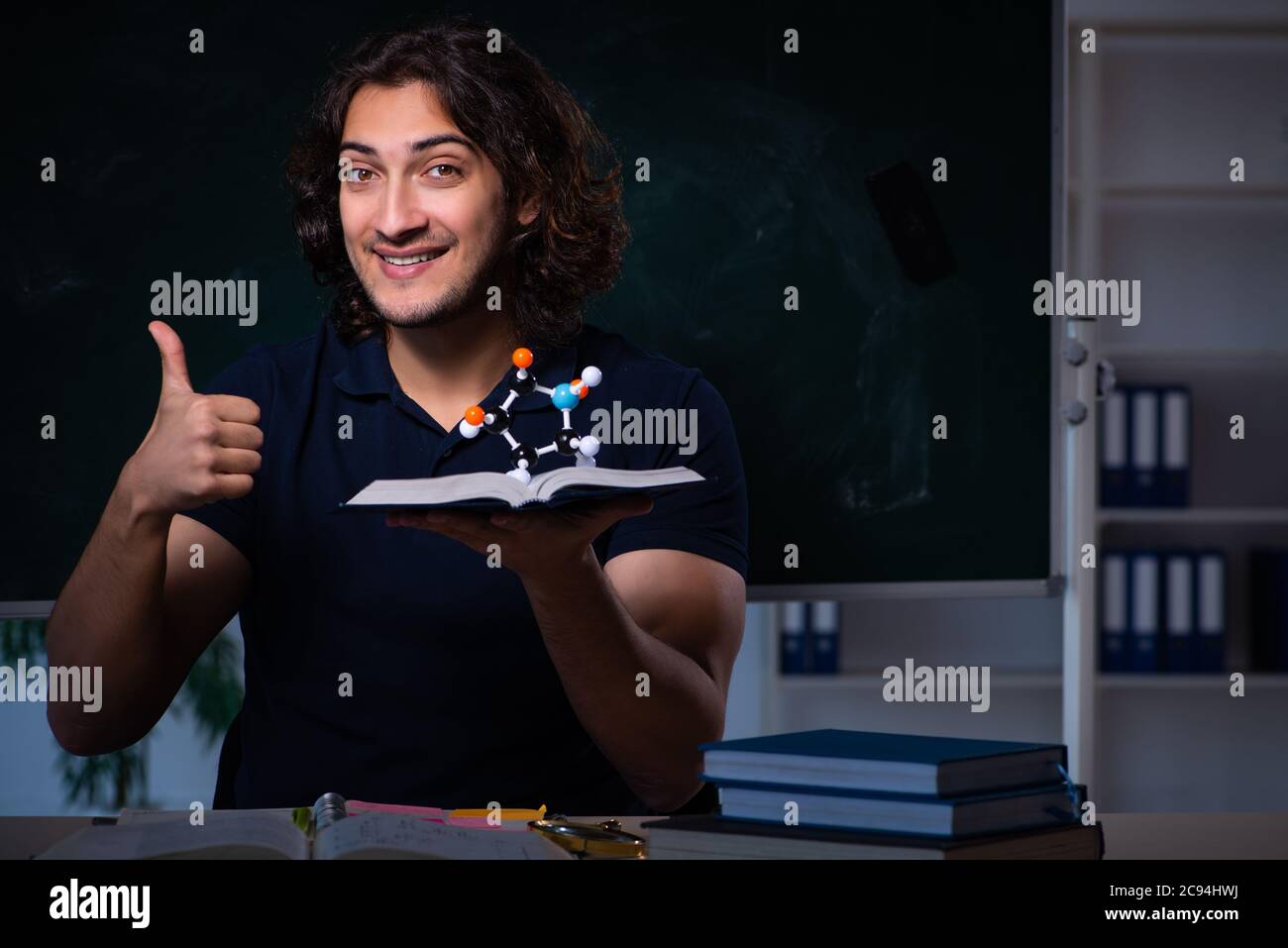 Young student in the classroom at night Stock Photo - Alamy
