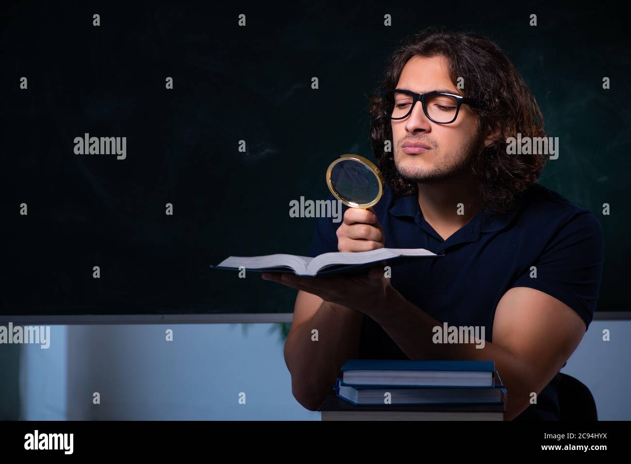 Young student in the classroom at night Stock Photo - Alamy