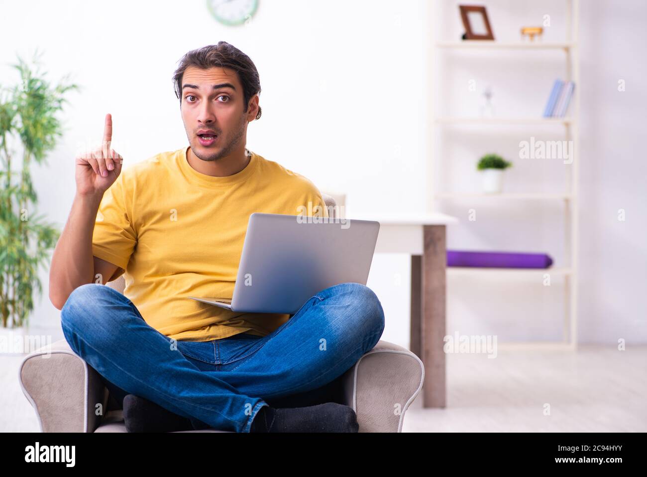 Young handsome man with computer at the home Stock Photo - Alamy