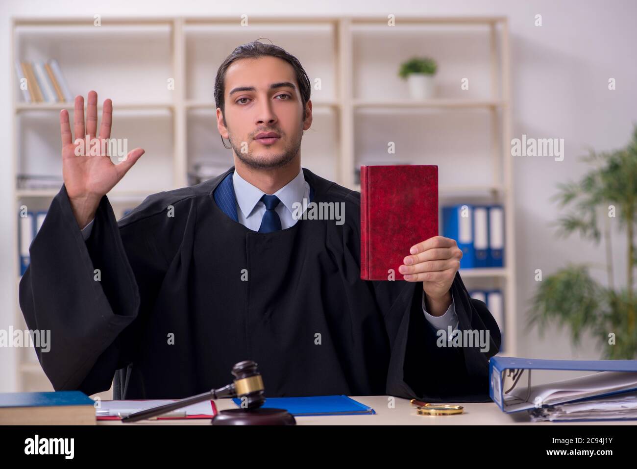Young judge working in courthouse Stock Photo - Alamy