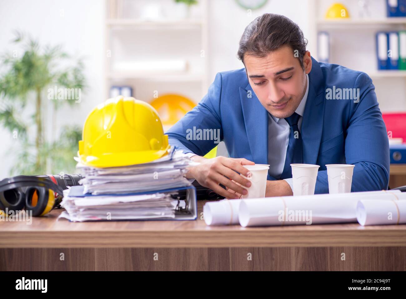 Young male architect working in office Stock Photo - Alamy