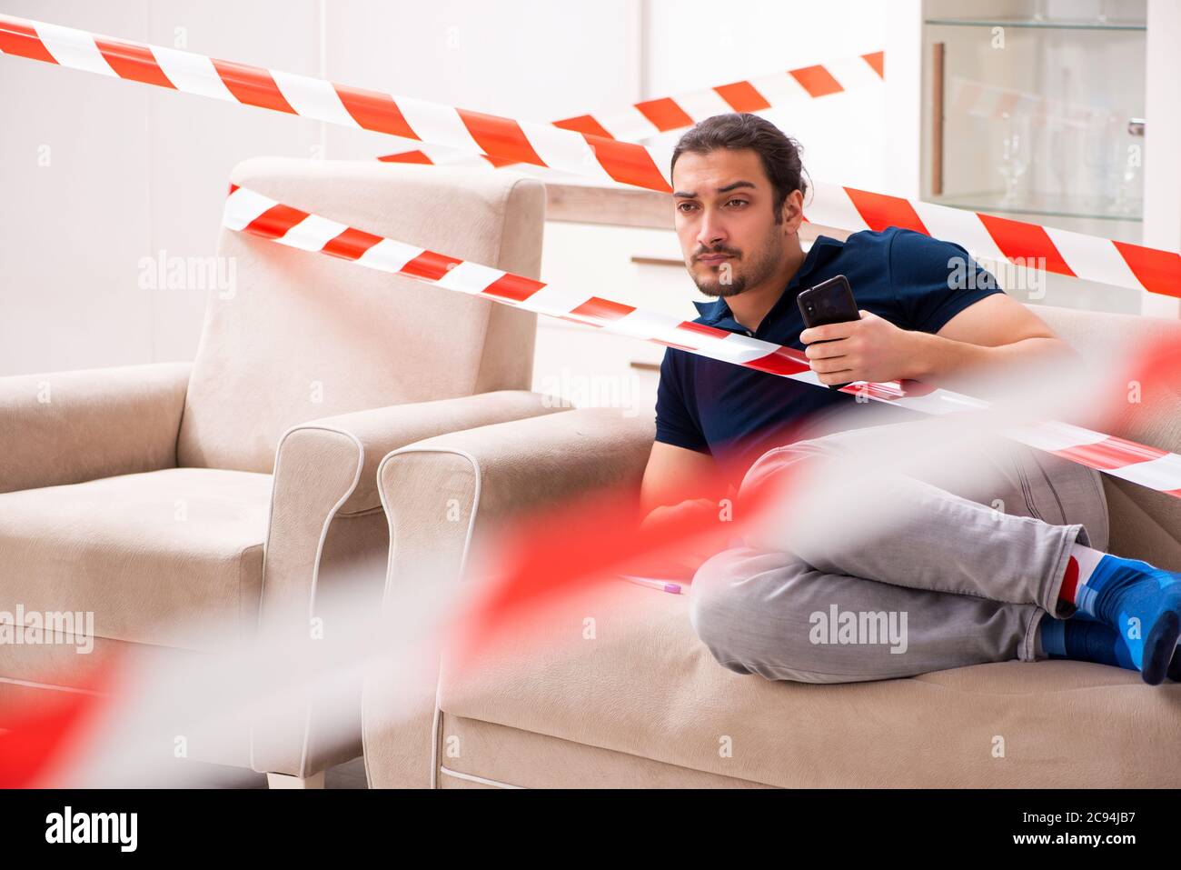 Young man feeling bored at the home in self-isolation concept Stock ...