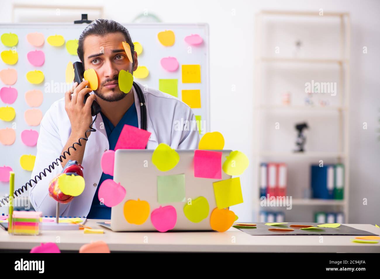 Young medic in conflicting priorities concept Stock Photo - Alamy