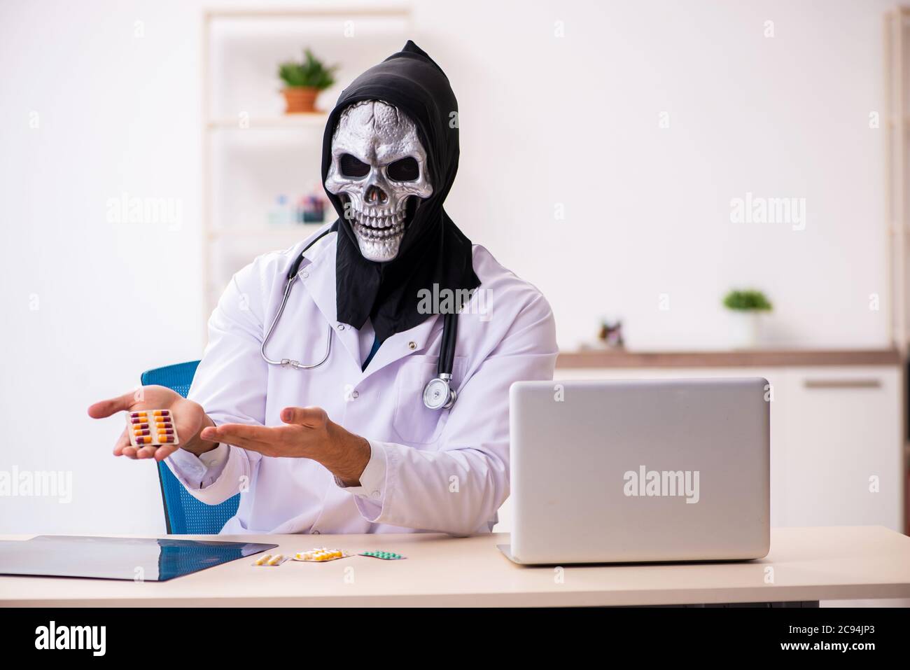 Male devil doctor working in clinic Stock Photo - Alamy