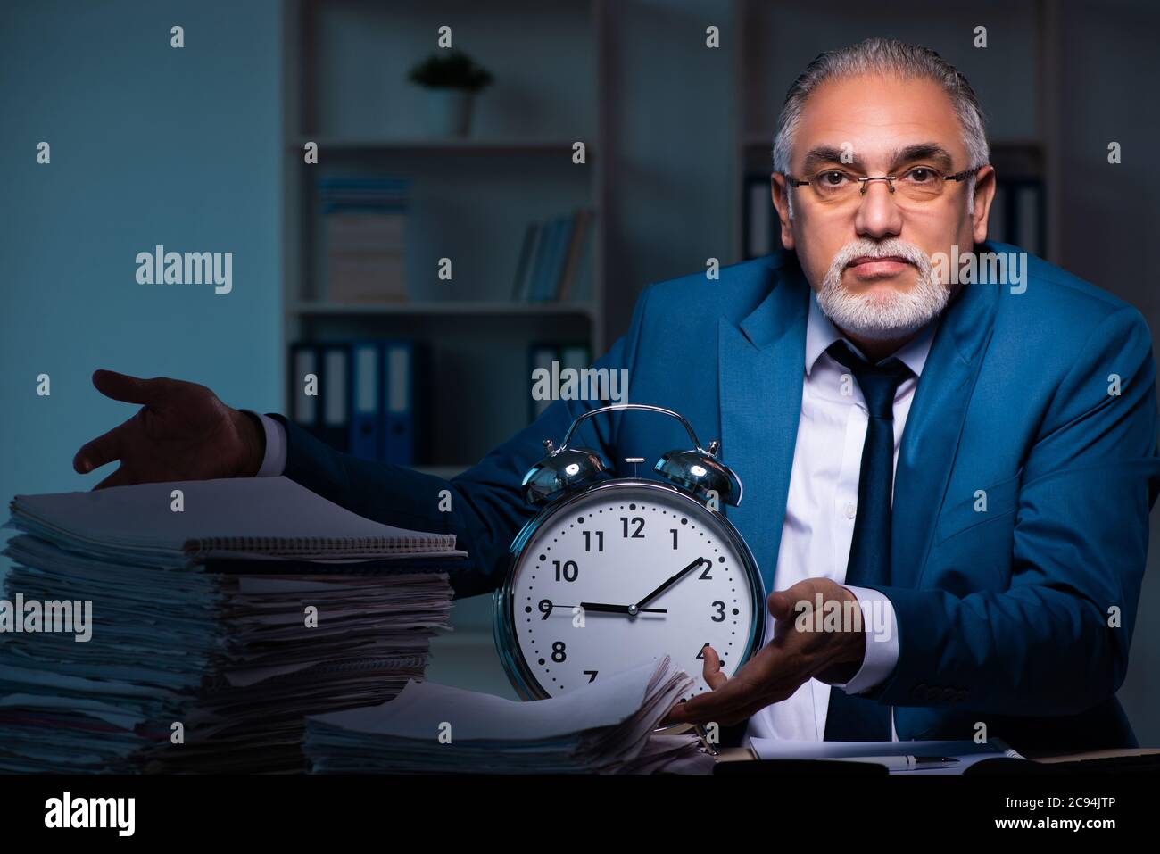 Old employee working late in the office Stock Photo - Alamy