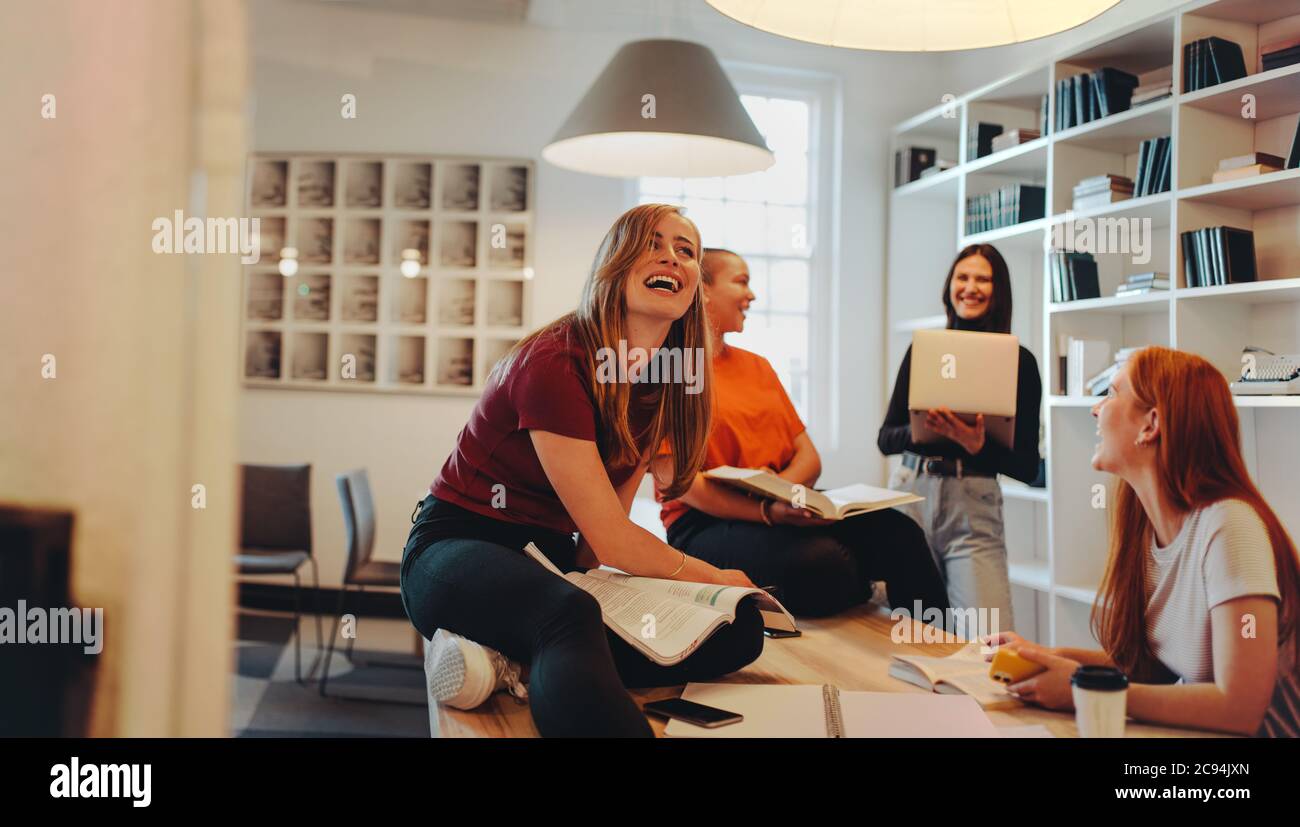 University friends socializing and studying together for exam in ...