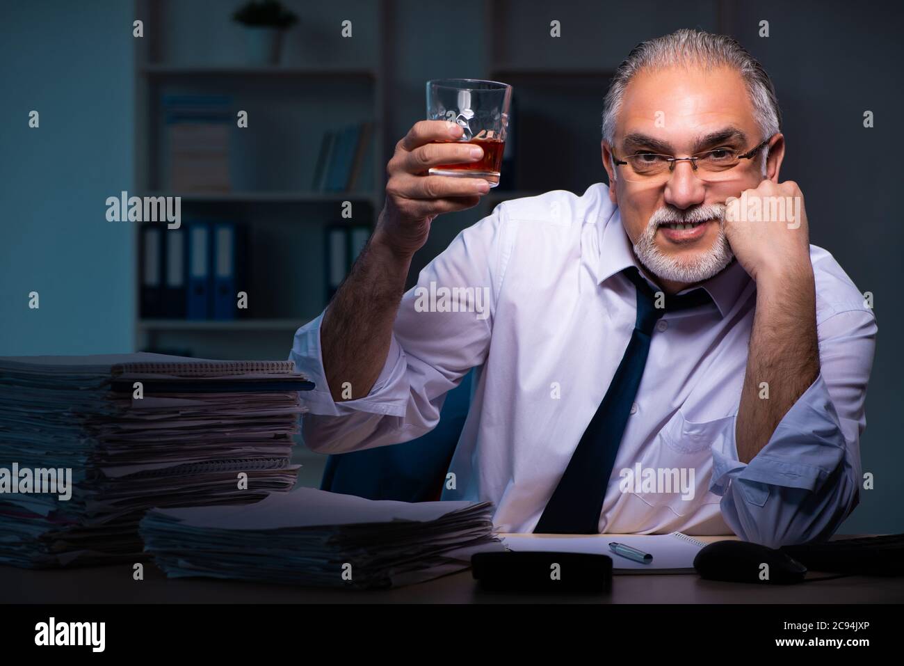 Old employee working late in the office Stock Photo - Alamy