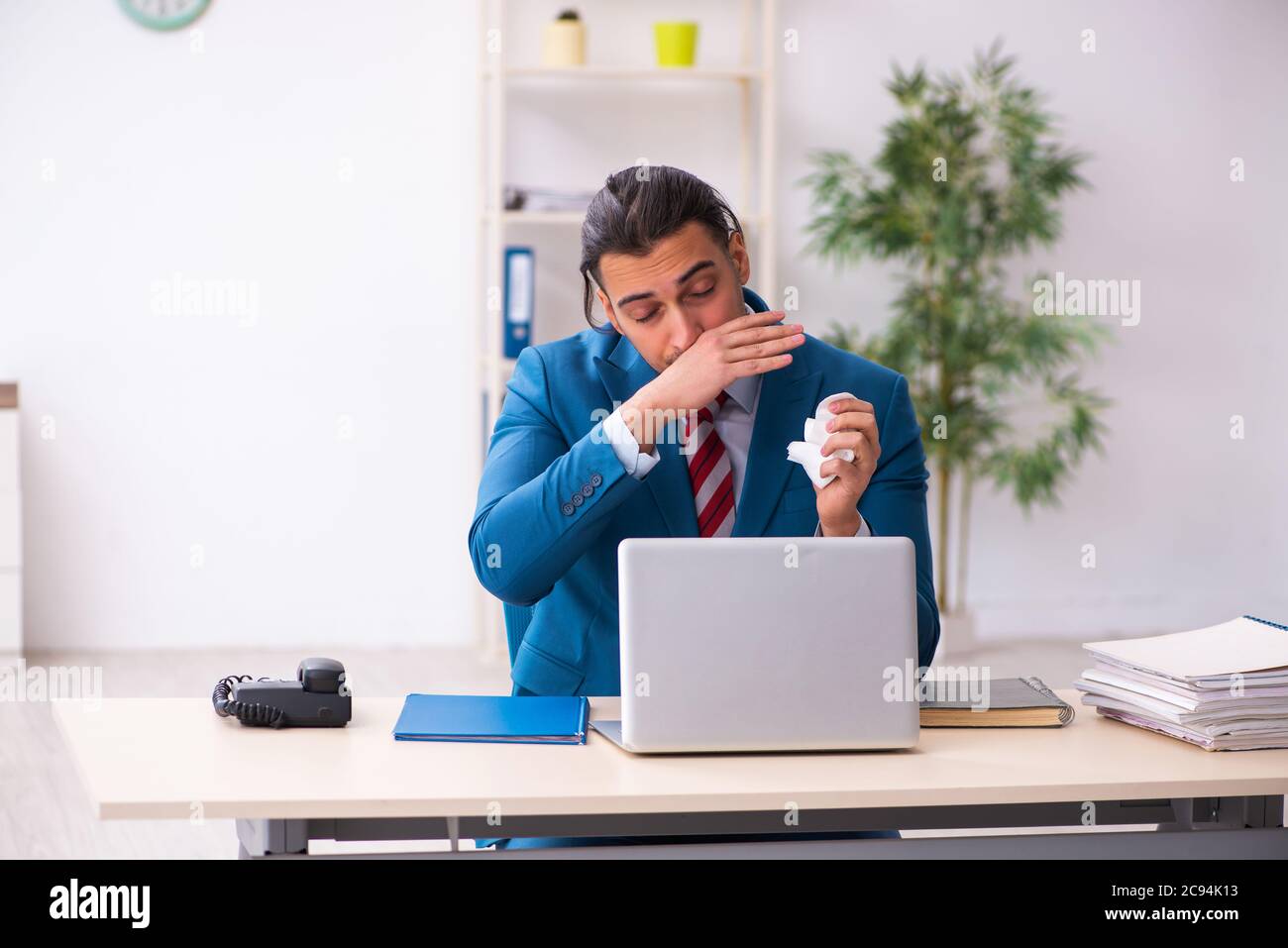 Sick employee suffering at workplace from covid-19 Stock Photo - Alamy