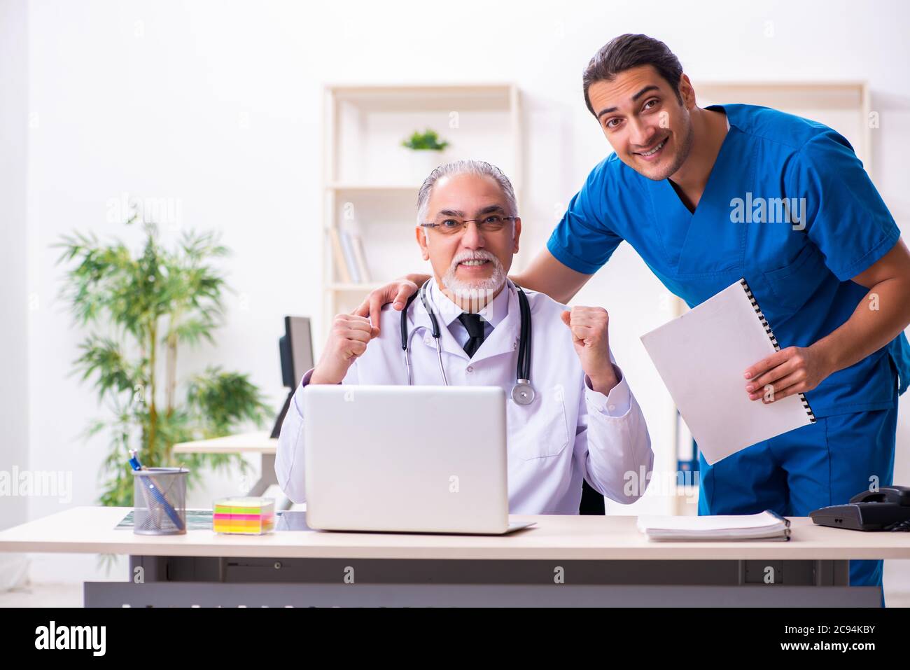 Two male doctors working in the modern clinic Stock Photo - Alamy