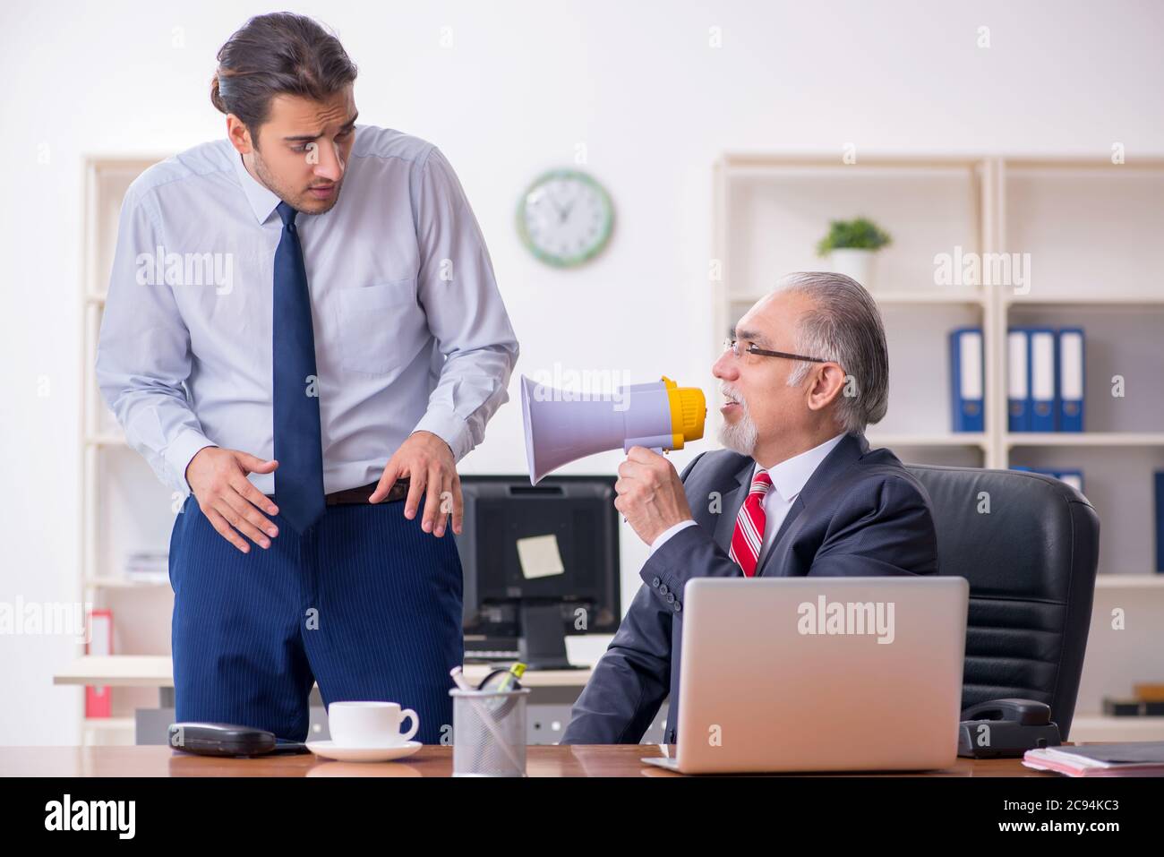 Old boss and young employee in the office Stock Photo - Alamy