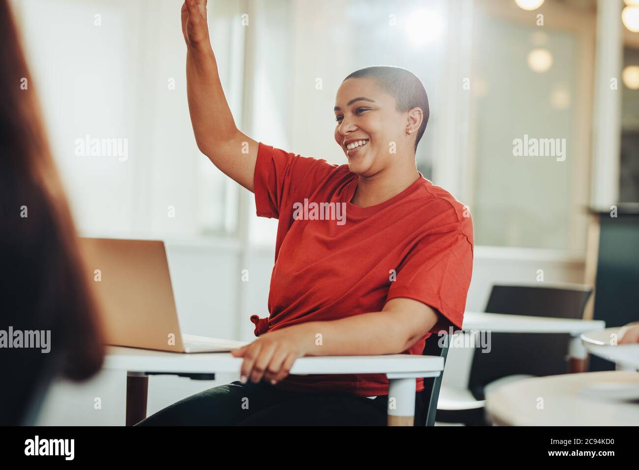 Student asking question whilst attending lecture on campus. Female ...
